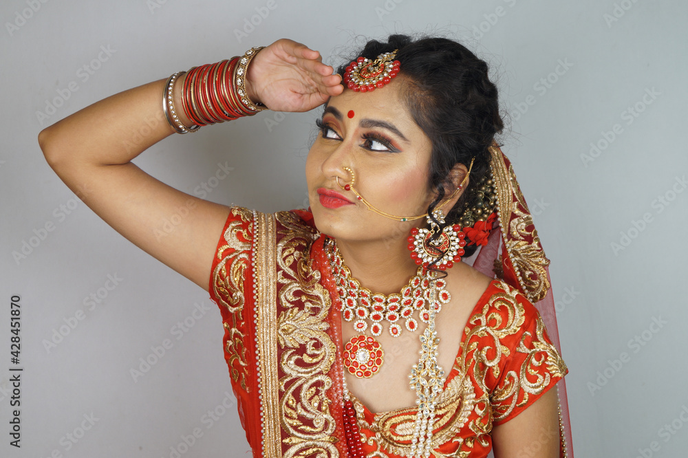 Beautiful Indian woman wearing her red wedding dress with bridal makeup ...