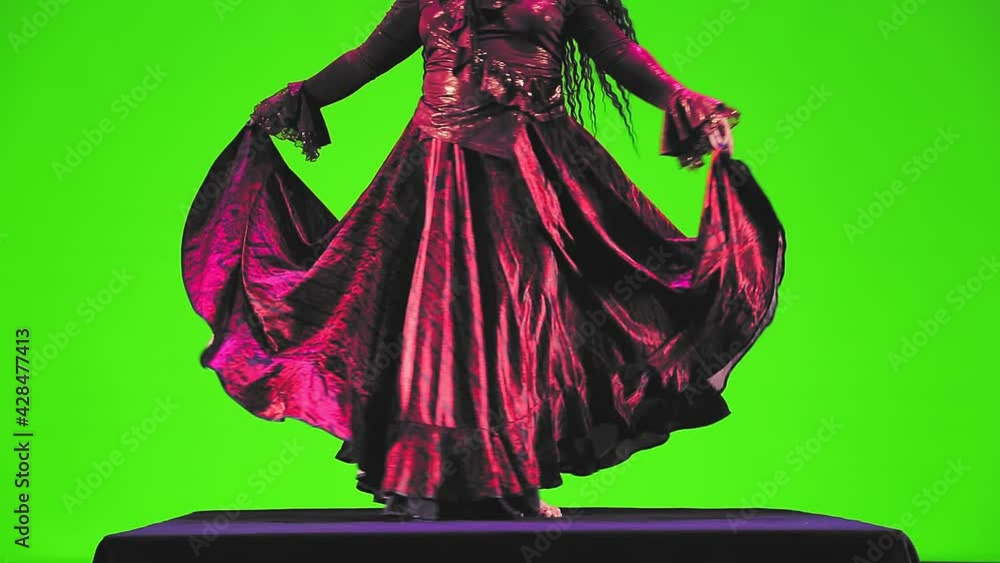 A barefoot gypsy woman without a face with long black hair in a red ...