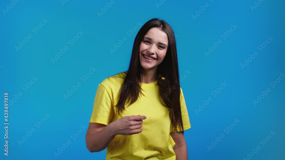 Young woman showing - Hey you, come here. Pretty girl in yellow wear ...