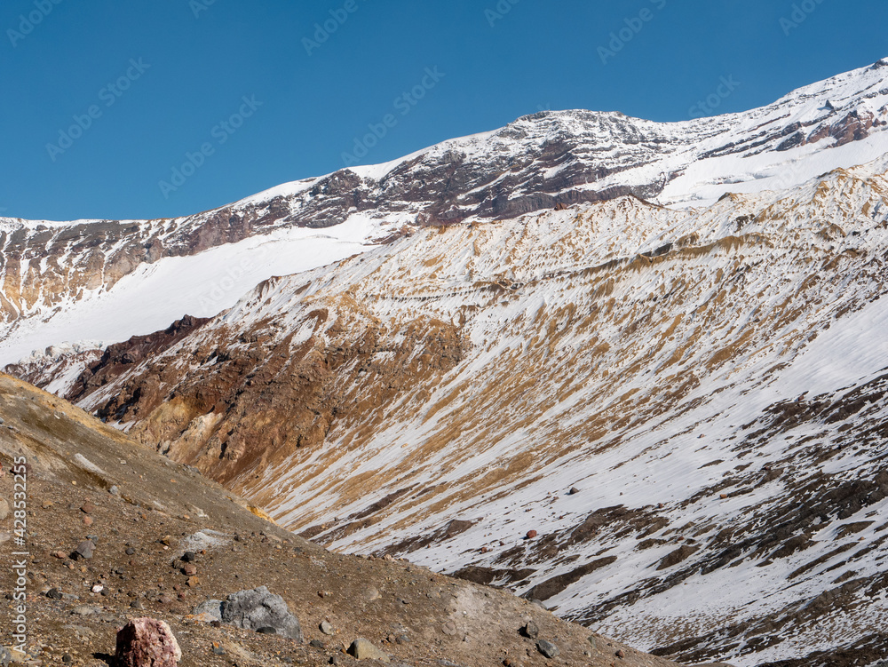 Climbing tourists to the Mutnovsky volcano. View of the snow-capped ...