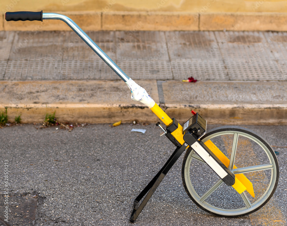 Surveyor's wheel or clickwheel used to measure distances on roads or ...