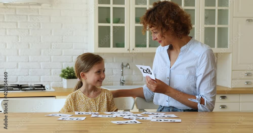 Teacher helps to little girl with mathematics. Mom practice maths with ...