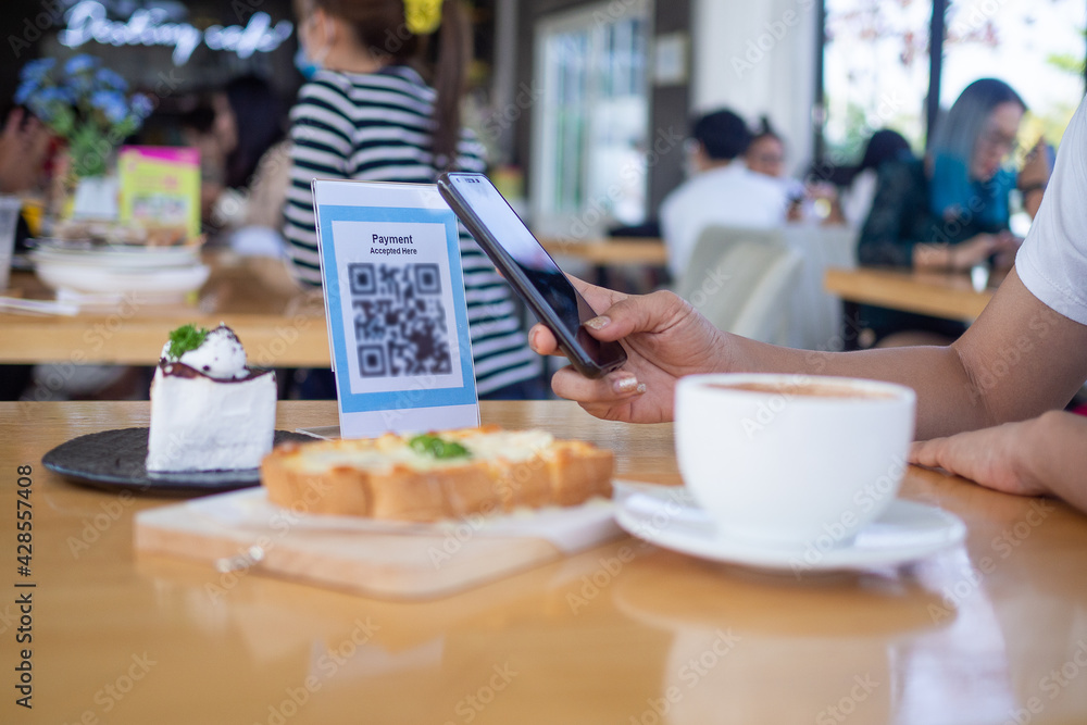 hands are using the phone to scan the qr code to select food menu. Scan ...