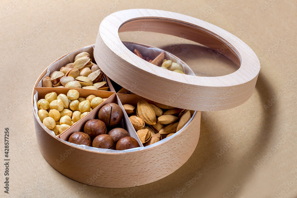 wooden round gift box with the lid open and set of different types of ...
