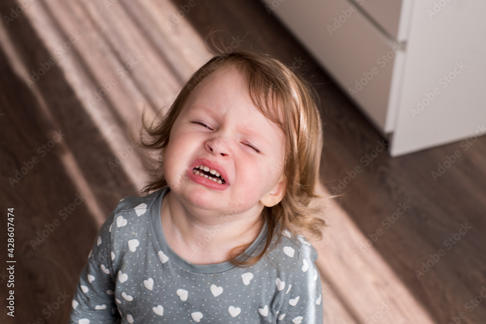 the little girl is crying and acting up. the child is in a bad mood ...