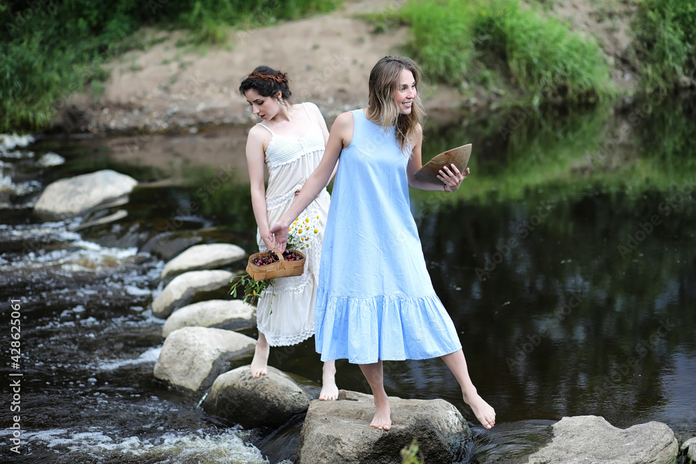 Beautiful girls in dresses on the river Stock Photo | Adobe Stock