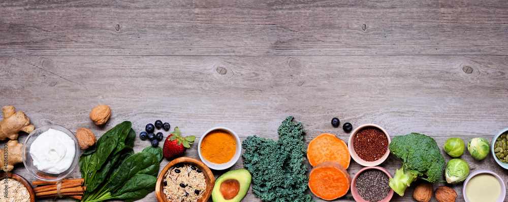 Set of healthy food ingredients. Top view bottom border on a wood ...