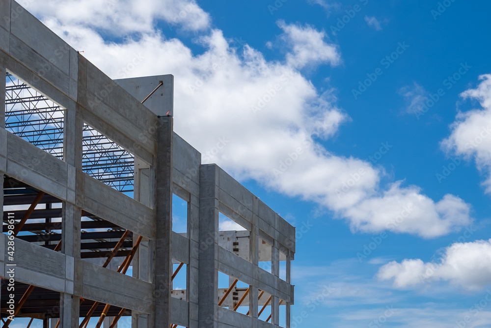 A large multiple storey precast grey concrete building with steel beams ...