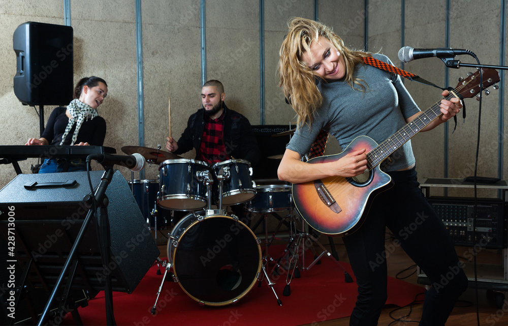 Group of young musicians with passionate emotional female vocalist and ...