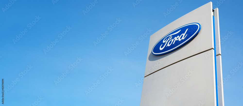 Ford American car company sign, clear blue sky background outside ...