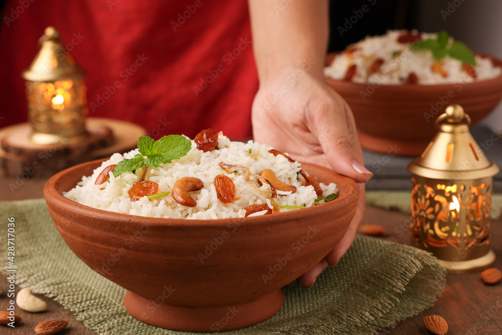 Woman hand serving Chicken biryani Spicy Indian Malabar biryani ...