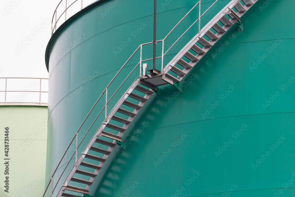 green steel silos with stainless steel ladder and handrail. liquid ...