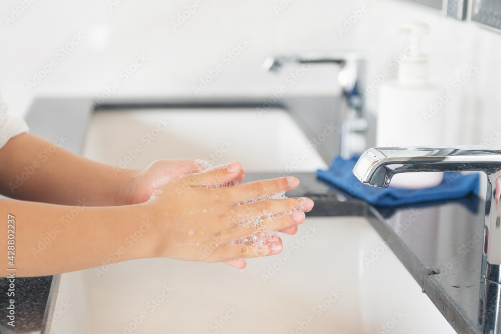 asian child girl student washing hands at the outdoor wash basin in the ...