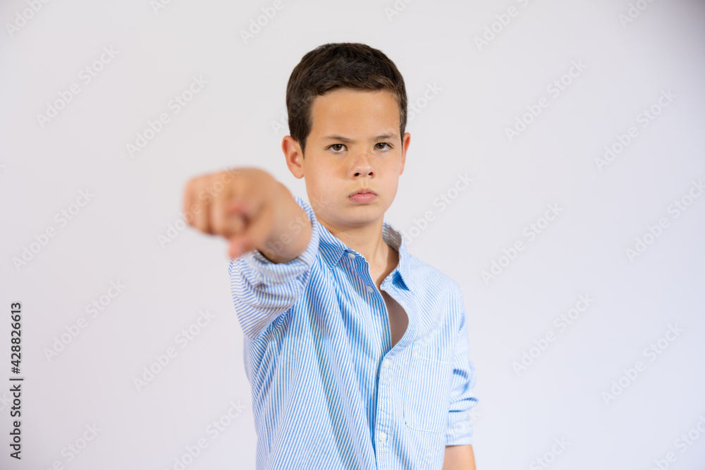 Little boy with angry face pointing to camera isolated over white ...
