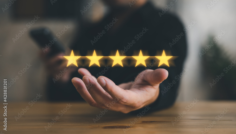 Customer satisfaction concept. hand holding the stars to complete five ...