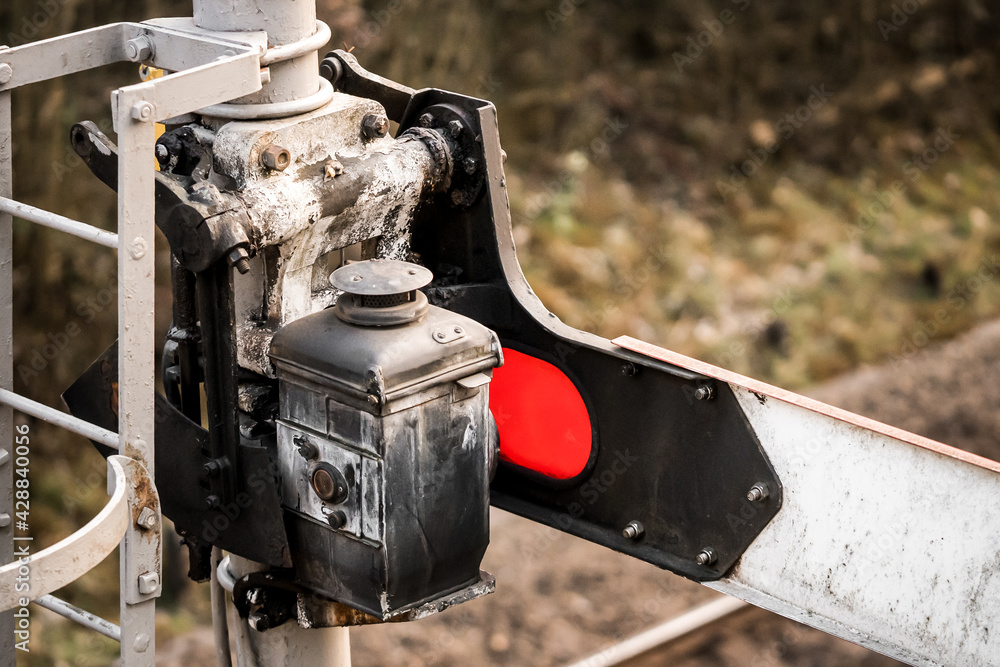 Old railway signal restored showing red stop light and lap behind ...
