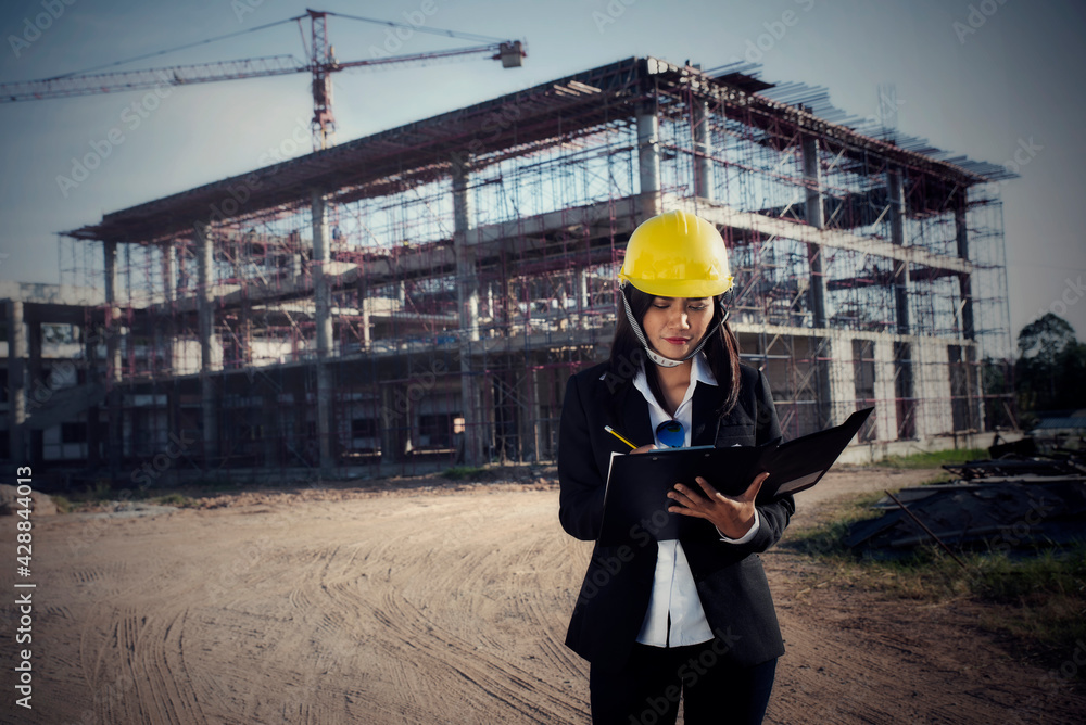 Asian woman engineering fill out form or inspect in front of ...