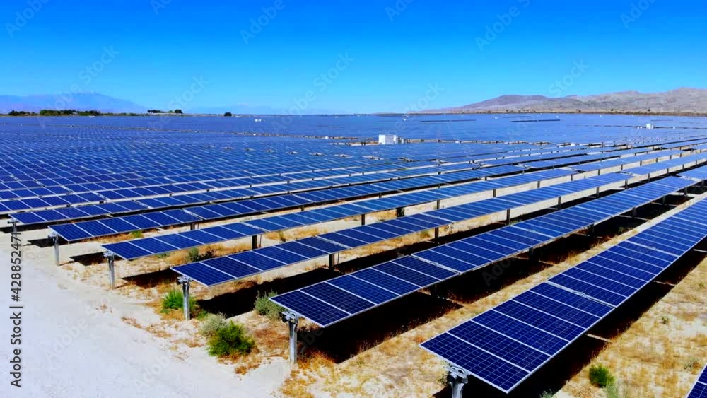 Massive solar photovoltaic PV farm lateral aerial 4k drone tracking ...