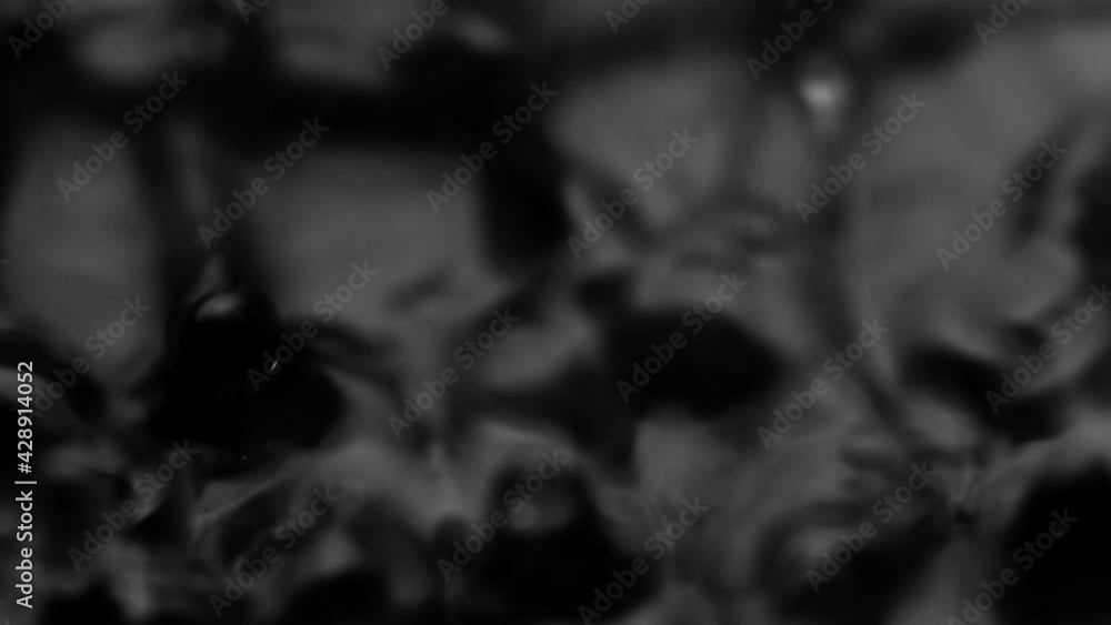 Splashes and drops on the surface of the liquid. Abstract Black ...