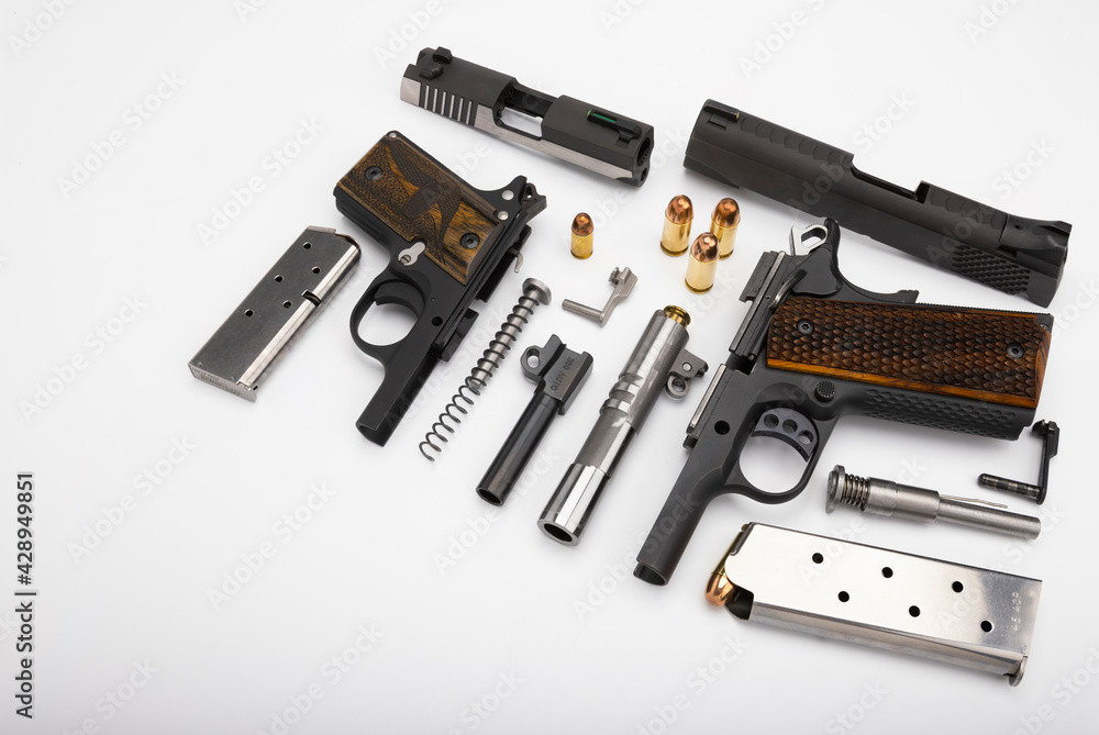 Guns , Part of Semi automatic pistol handguns with .45 bullets on white ...