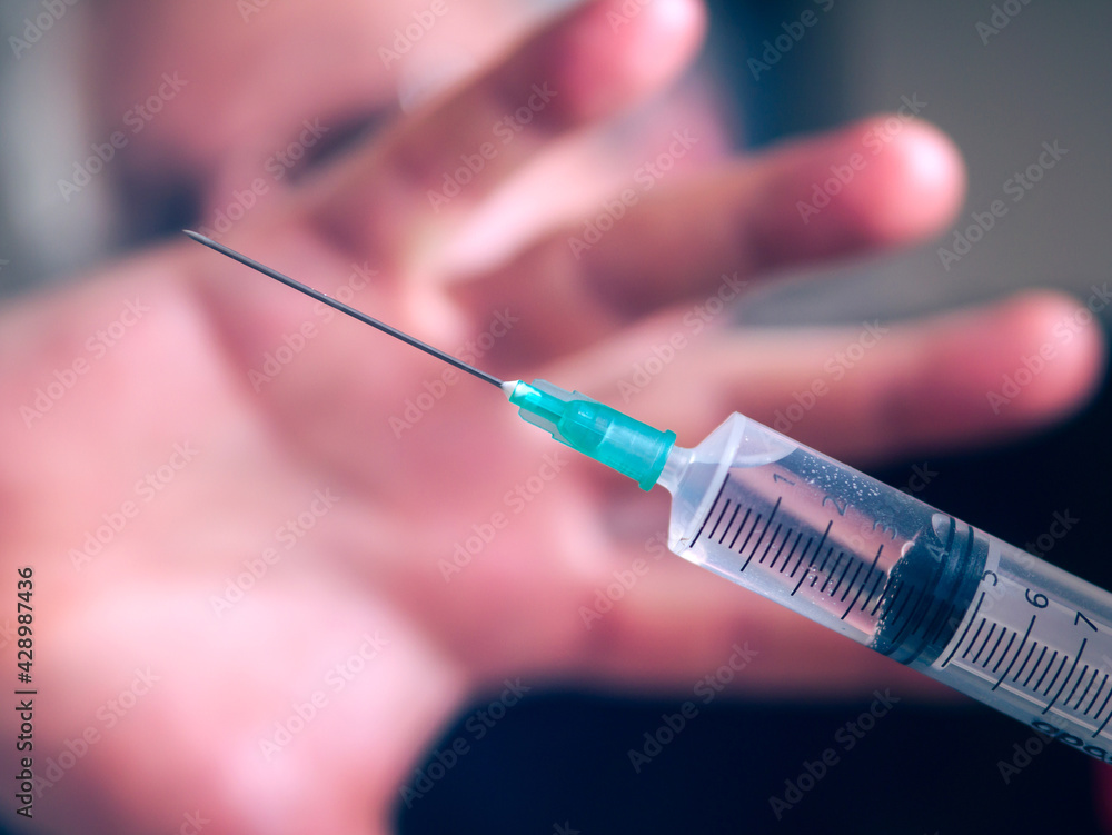 Hand symbolizes the refusal of vaccination syringe or other medical ...