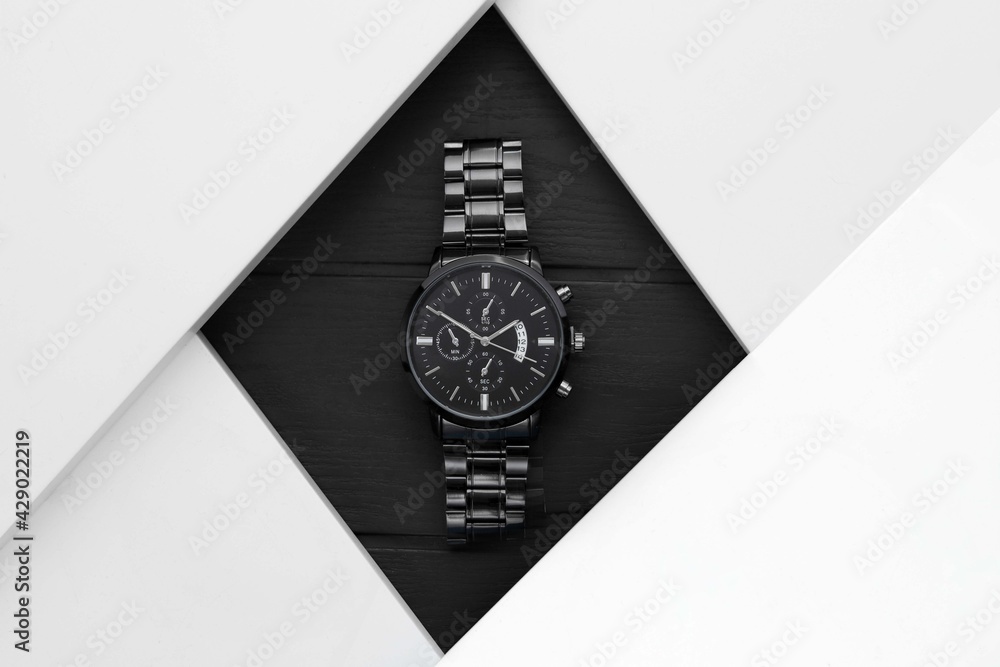 Luxury black watch on black and white table area. Monochromatic concept ...