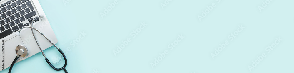 Stethoscope keyboard laptop computer isolated on blue background ...