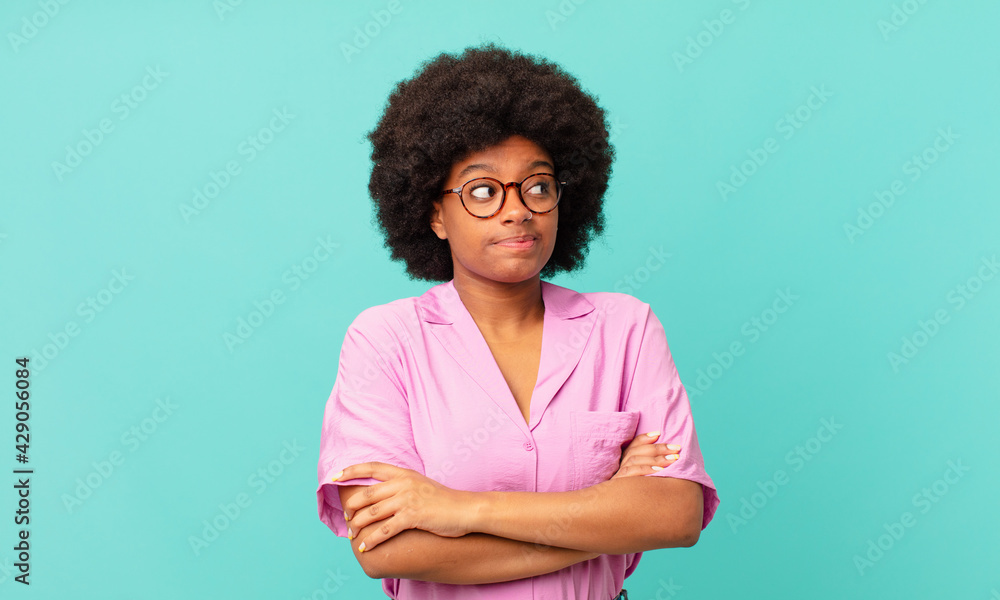 afro black woman shrugging, feeling confused and uncertain, doubting ...