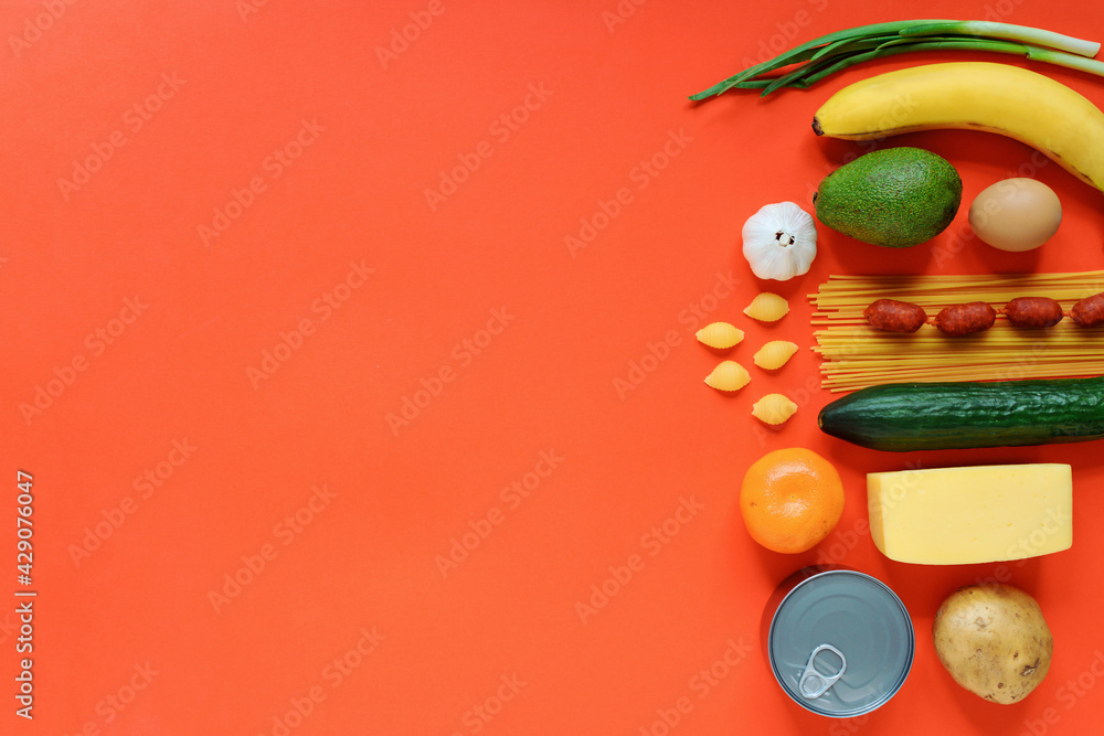 Food products set on the red background, copy space. Canned food ...