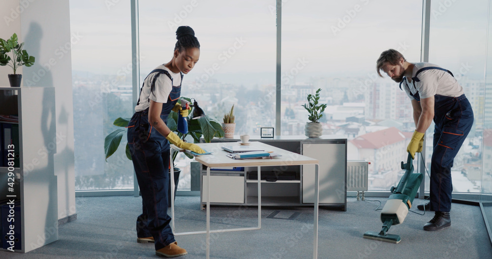 Janitor team of multi-ethnic people cleaning corporate office company ...