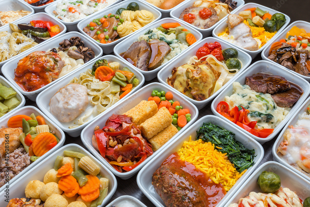 Airplane food presentation with variety of in flight meals. Flight ...