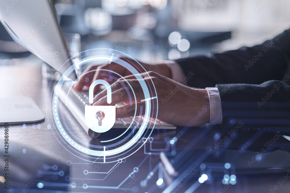 A programmer is typing a code on computer to protect a cyber security ...