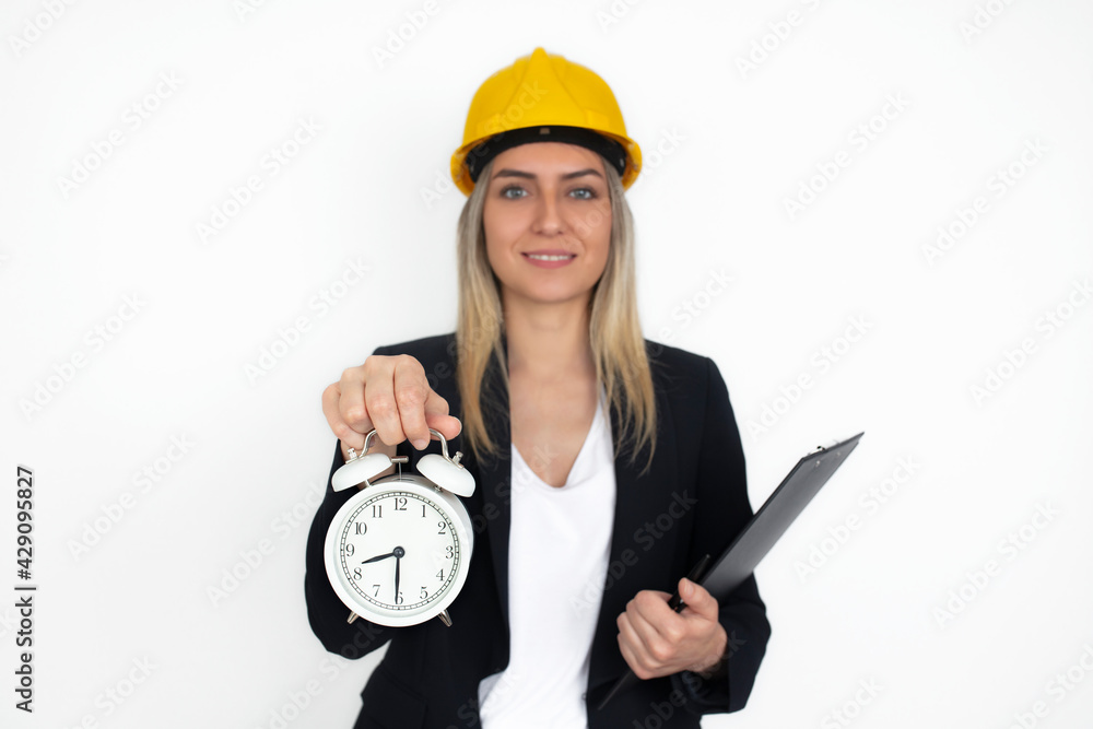 young engineer woman. Business woman holding clock in hand. Their ...