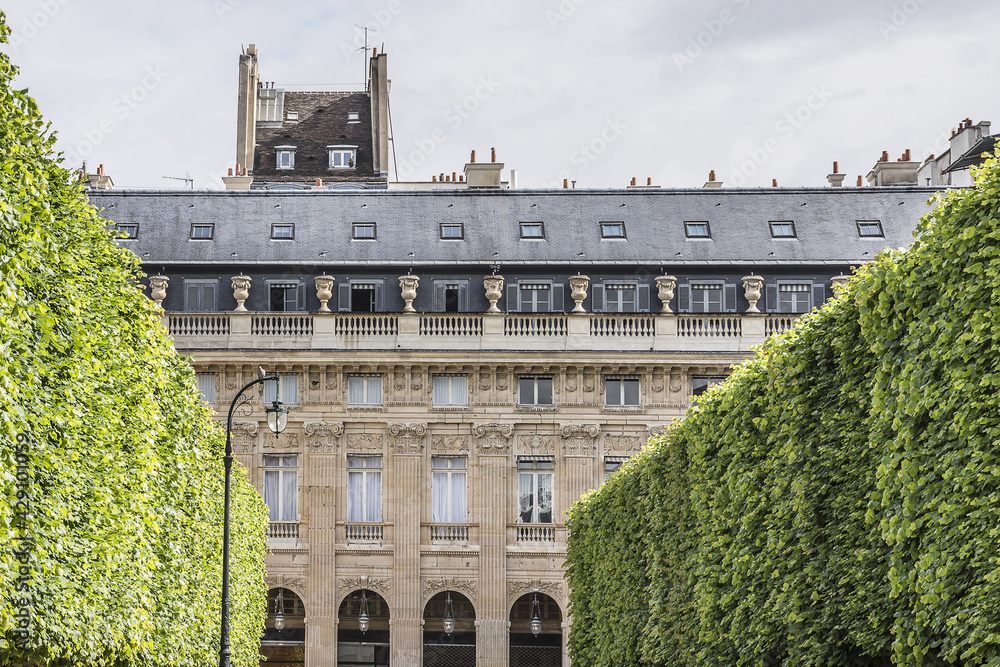 Architecture of ancient buildings in public garden of Palais-Royal ...