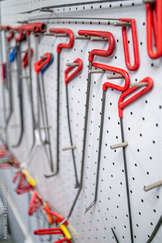 Bright colored special hooks using in PDR work process to remove dents ...