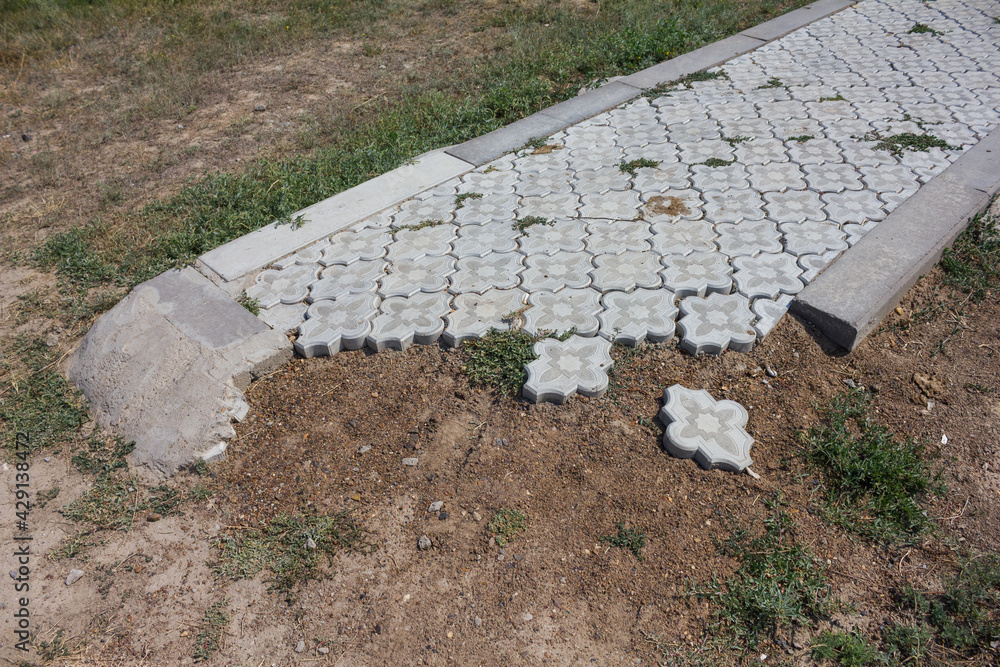 Destroyed sidewalk. Destroyed paving stone sidewalk. Poor quality ...