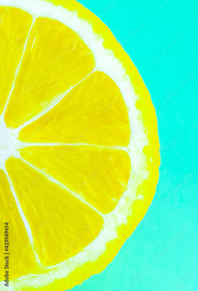 Close up photo of lemon texture on the blue background. Fruit cut in ...