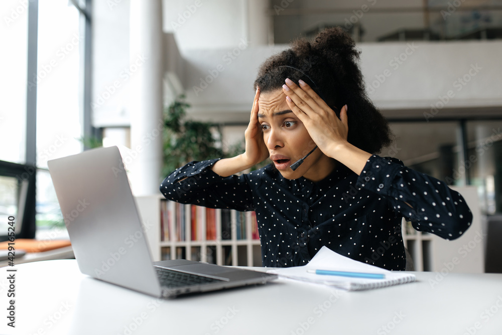 Irritated shocked young African American woman, employee, manager or ...