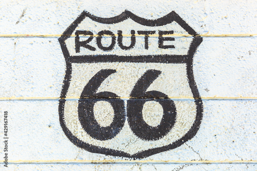Historic Route 66 road sign on a white wall in Barstow, California ...