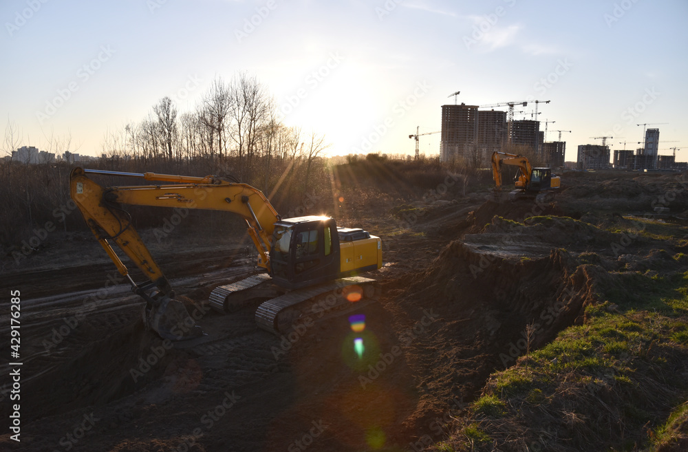 Excavator dig trench at construction site. Digging the pit foundation ...