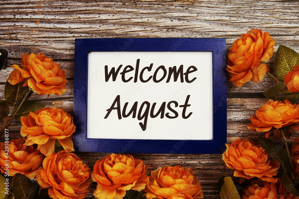 Welcome August text in blue border frame with flower decoration on ...