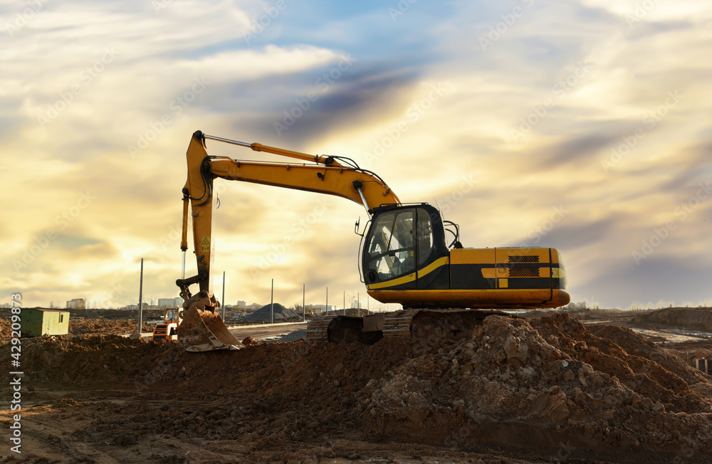 Excavator dig the trenches at a construction site. Trench for laying ...