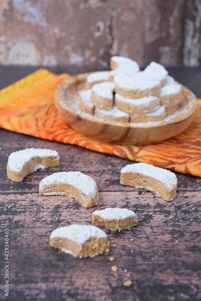 Putri Salju or crescent-shaped cookies coated with powdered sugar ...