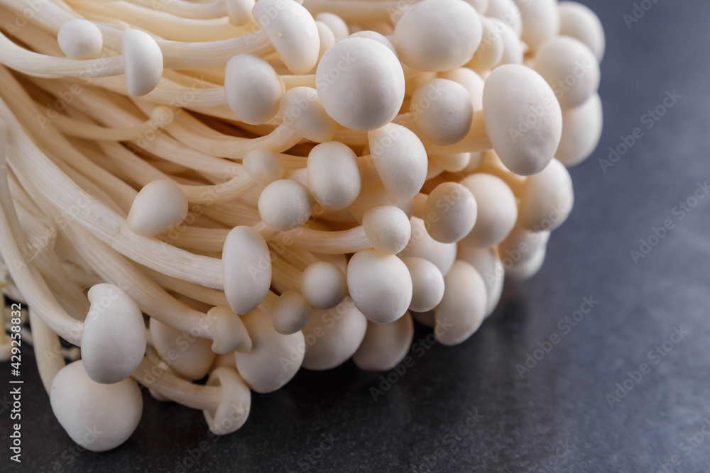 Fresh Enoki mushrooms on black background with selected focus.Enoki ...