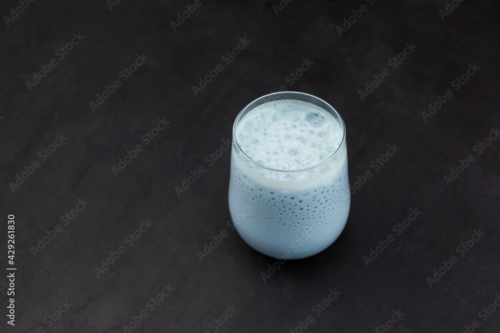 Ayran or kefir with blue spirulina. Fermented milk drink with bubbles ...