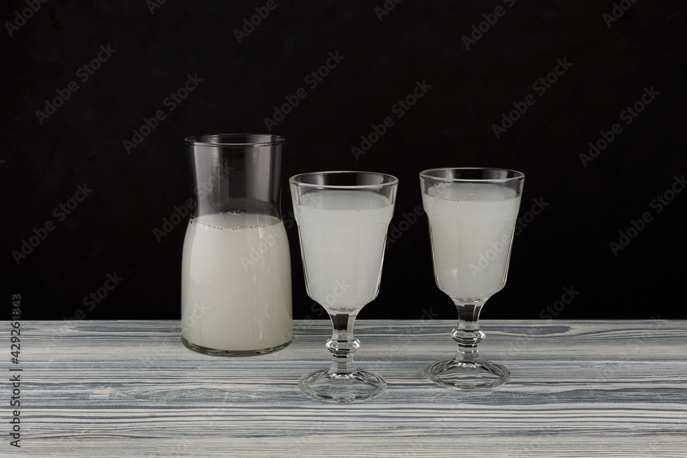 Pulque or pulke in drinking glasses on dark background. Traditional ...