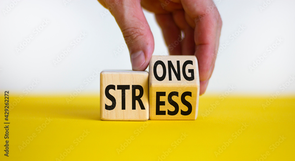 Strong stress symbol. Businessman turns wooden cubes with words 'strong ...