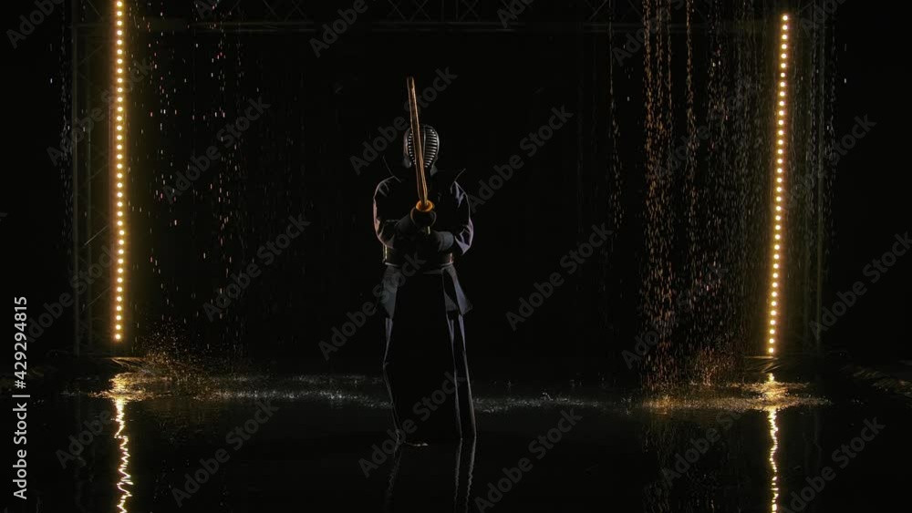 Japanese kendo fighter in fighting stance stabs with shinai. Man in ...