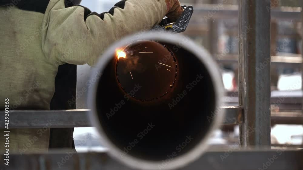 Pipe welding. Fire and sparks from welding inside the pipe. Welder's ...