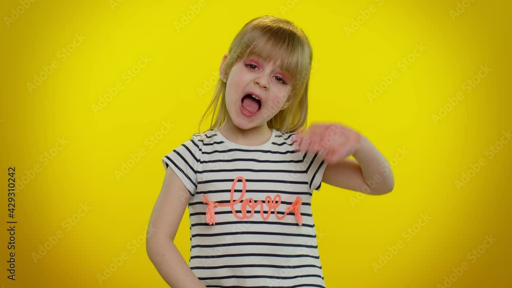 Hey you. Little blonde teen kid child girl in striped t-shirt shouting ...